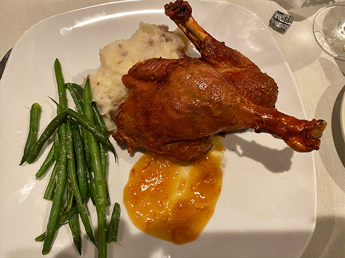 Duck that's achieved that magical mahogany glow, promising flavor that's as rich as the history surrounding you.