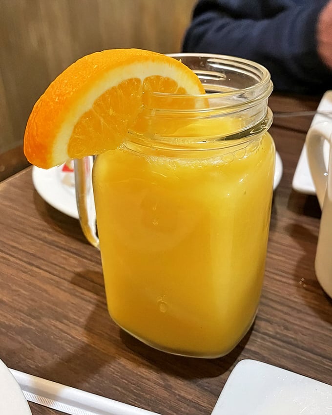 Fresh-squeezed orange juice served in a mason jar with a slice perched on the rim&mdash;liquid sunshine to wash down all that comfort food.