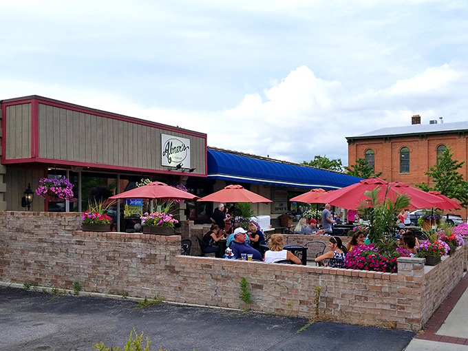 The brick-walled patio buzzes with conversation and laughter&mdash;a summer sanctuary where pink umbrellas provide shade for leisurely meals and cold drinks.
