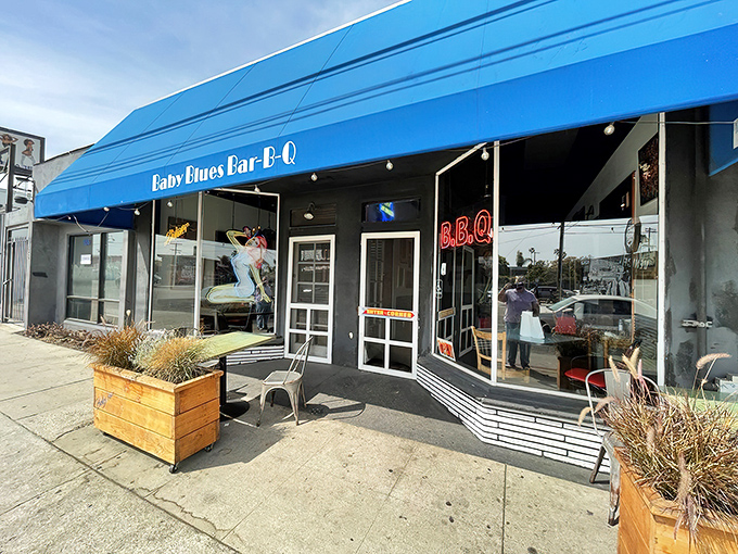 That iconic blue awning creates an oasis on the sidewalk, a beacon of hope for the hungry traveler seeking smoky salvation.