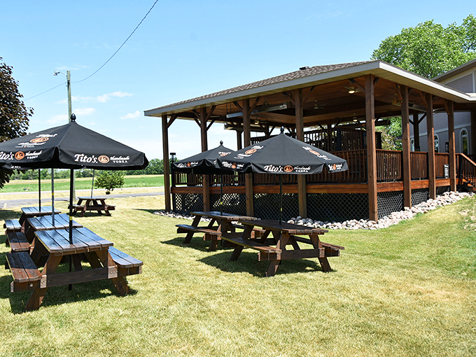 Picnic tables under Tito's umbrellas create an outdoor oasis. When Wisconsin's weather cooperates, this becomes the hottest real estate in Portage.