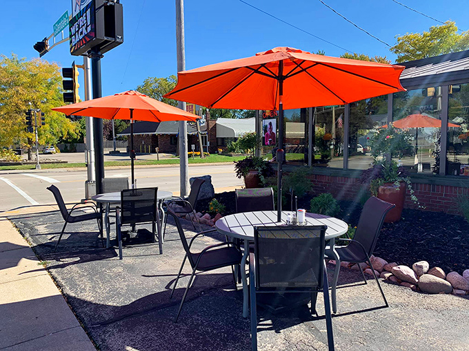 Wisconsin's precious outdoor dining days deserve celebration. These bright orange umbrellas create sidewalk oases perfect for people-watching while savoring those legendary hash browns.