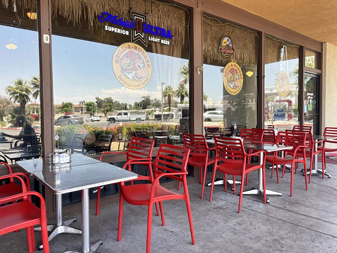 The outdoor seating area offers a front-row view of Palm Desert life passing by, while those red chairs practically shout, "Sit here and stay awhile!"