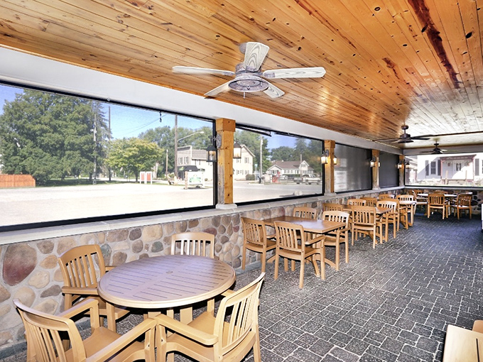Sunshine streams through windows in this cozy patio area. The perfect spot to watch the world go by while savoring pizza perfection.