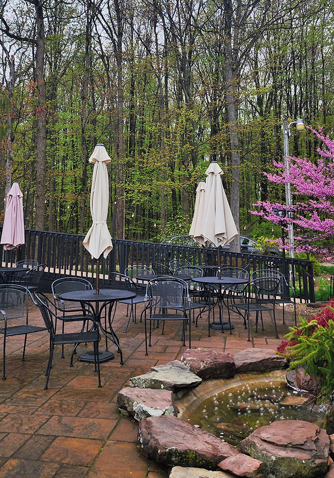 Spring blossoms frame this peaceful patio retreat. Nature doesn't just surround this space—it embraces it with seasonal splendor and tranquil water features.