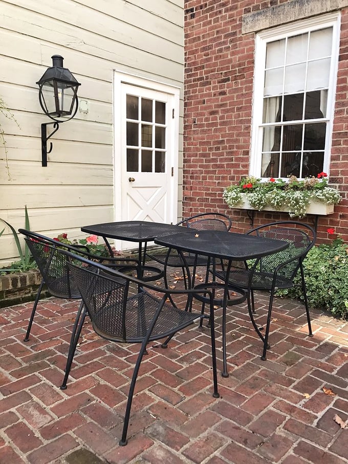 Even the outdoor seating whispers of history, with brick pathways and flower boxes that have welcomed guests through changing seasons for nearly two centuries.