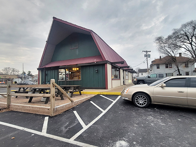 The distinctive A-frame exterior stands as a beacon of burger excellence. Those picnic tables outside? Summer dining at its most authentic.