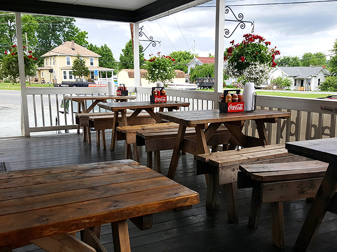 The covered porch offers a front-row seat to barbecue bliss&mdash;these picnic tables have witnessed countless food-induced moments of pure happiness.