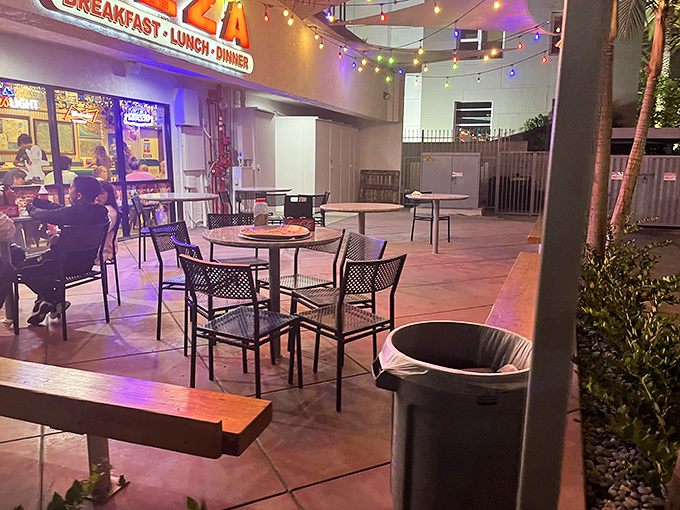 The outdoor seating area where pizza tastes even better under the California night sky. String lights make everything more magical.