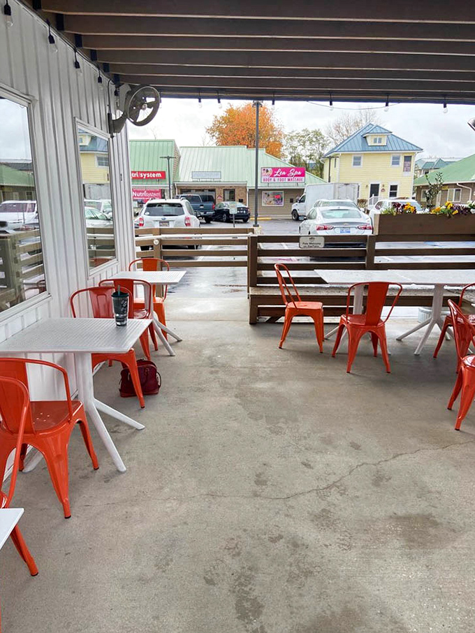 Orange chairs pop against concrete in this outdoor seating area&mdash;a perfect perch for people-watching while devouring the day's catch.