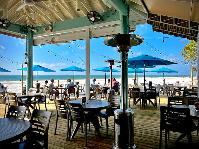 Where "social distancing" just means leaving room for the pelicans. These tables have witnessed more perfect sunsets than most photographers.