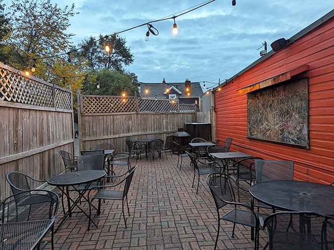 As twilight falls, string lights transform the patio into a magical pizza garden. Some of life's best moments happen at simple tables under open skies.