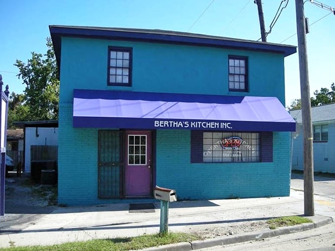 The distinctive blue exterior with purple awning serves as a landmark for hungry locals—"Turn at Bertha's" is common direction-giving in these parts.