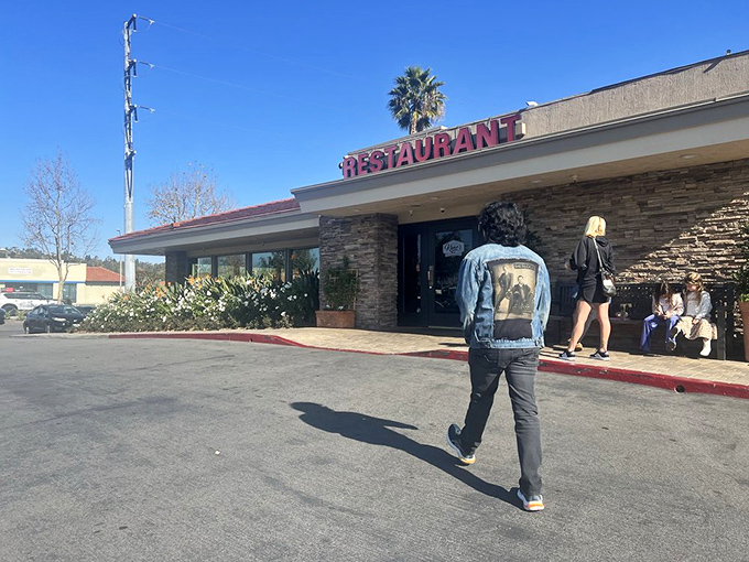 Even the parking lot welcomes you with open arms, promising good times just beyond those stone-accented walls.