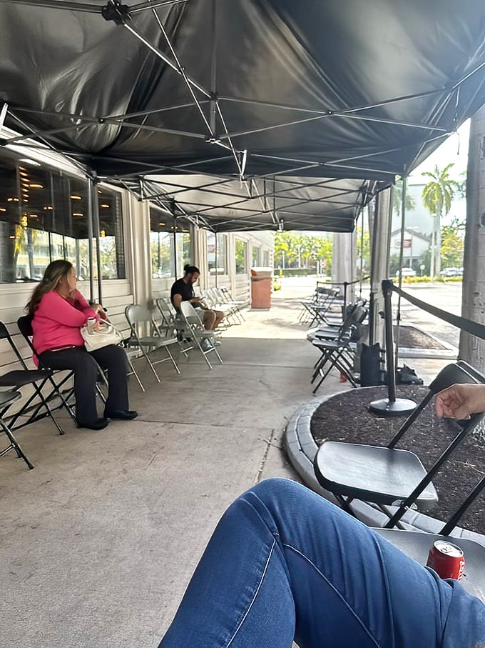 The outdoor waiting area with portable seating shows how popular this place gets during peak barbecue hours.