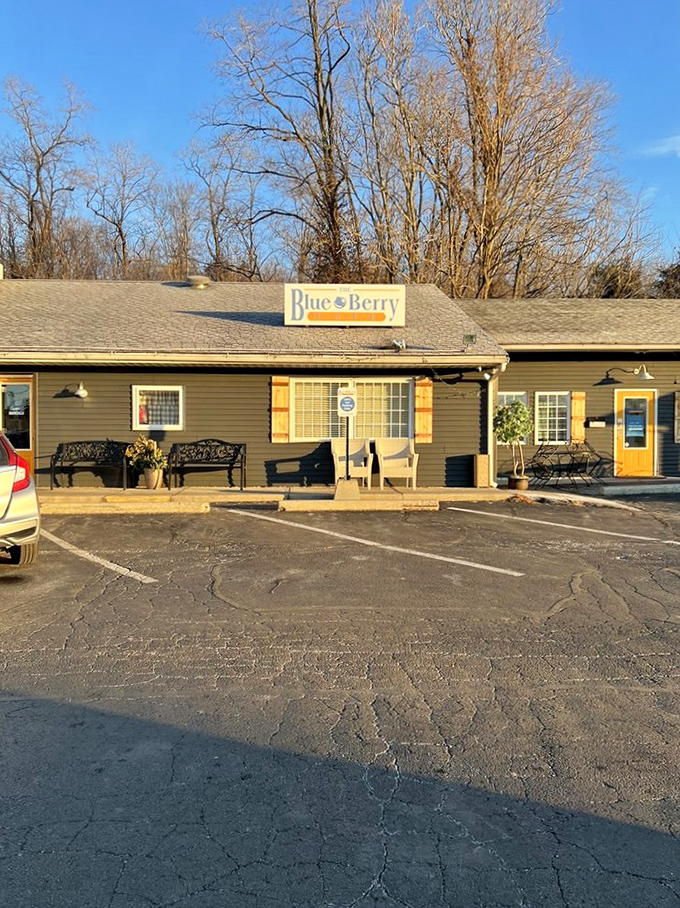 Morning sunshine bathes the Blueberry Cafe's exterior, while benches outside invite you to savor the afterglow of breakfast bliss.