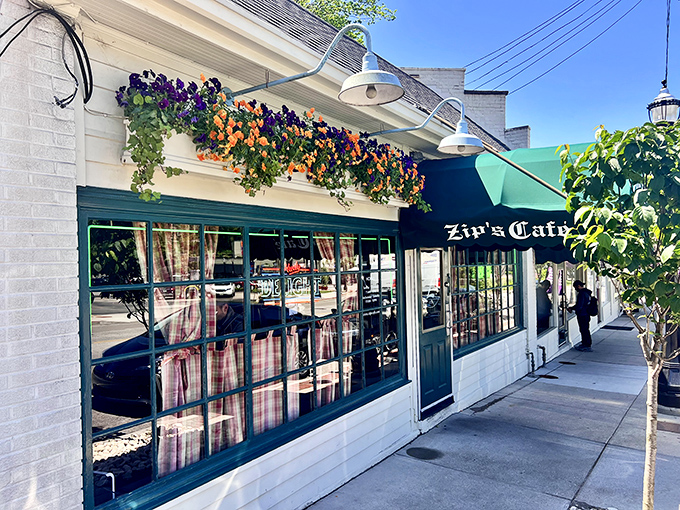 Spring flowers cascade from window boxes, adding a pop of color to Zip's classic white brick exterior. It's the kind of place that makes you slow down and appreciate simple pleasures.