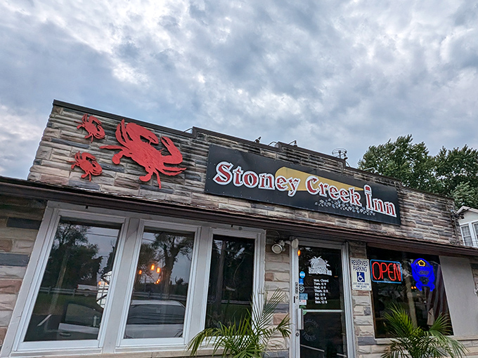 Three red crabs stand sentinel above the entrance, like crimson guardians promising delicious treasures to those who enter.