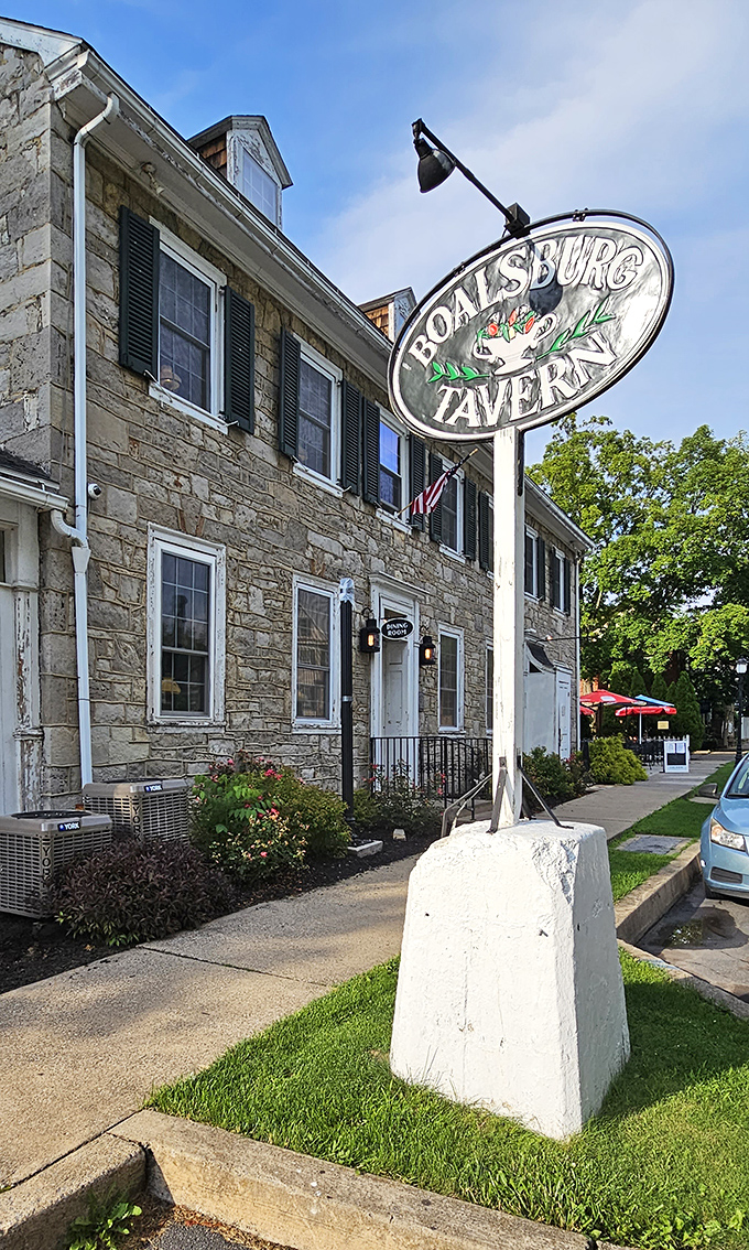 The iconic Boalsburg Tavern sign welcomes hungry travelers like a lighthouse beacon for those navigating the seas of culinary mediocrity in search of something authentic.