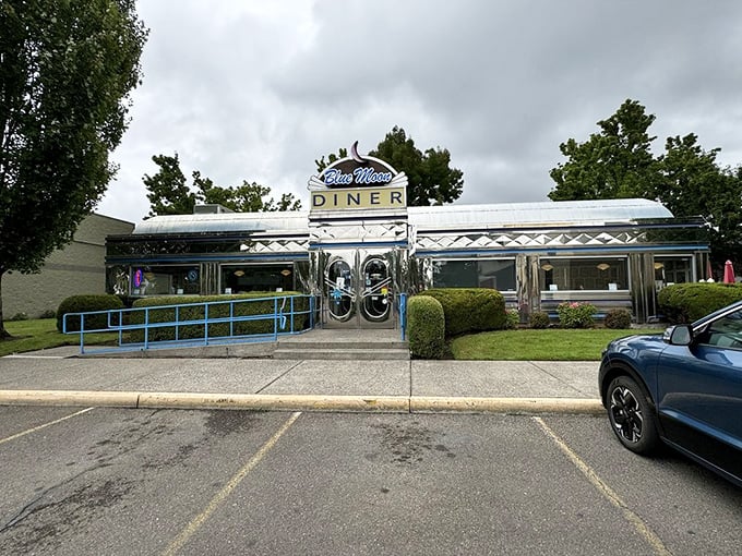 Rain or shine, this chrome diner stands ready to serve. The classic exterior promises timeless comfort food waiting just beyond those gleaming doors.
