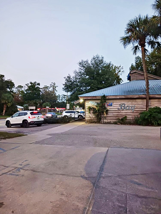 As evening falls, the Blue Water Bay sign glows like a beacon, guiding hungry travelers to this unassuming temple of seafood excellence.