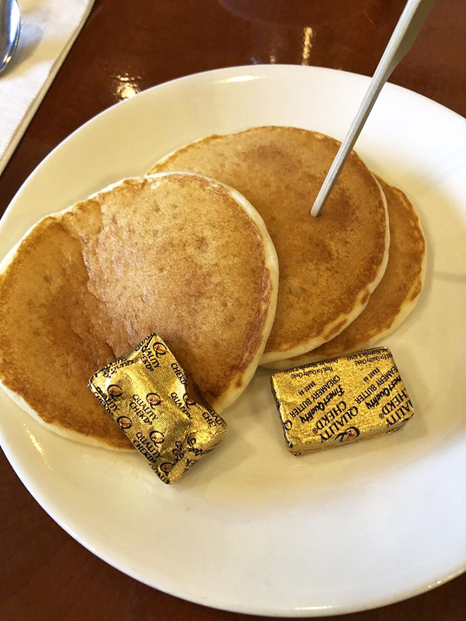 Golden pancakes with butter pats standing by for duty. Simple, perfect circles of happiness that make you wonder why you ever bother making them at home.