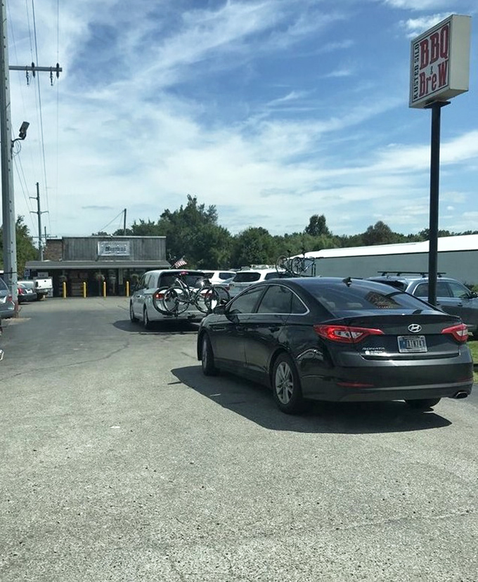 A parking lot filled with vehicles of people making excellent life choices. Cars from counties away proving that great barbecue is always worth the drive.