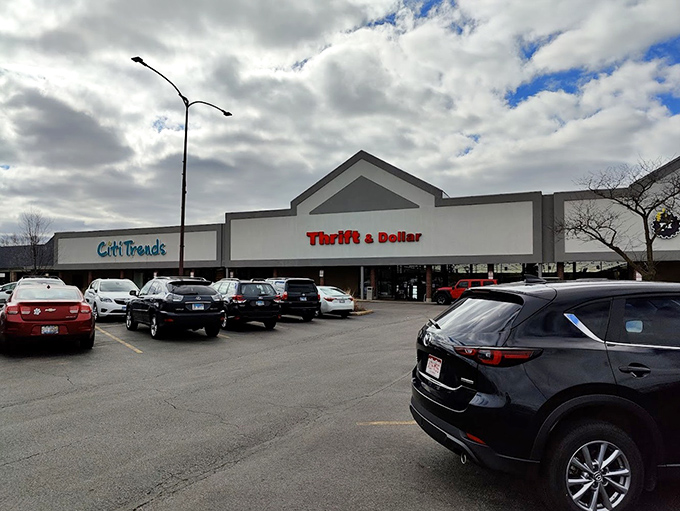 A parking lot full of cars signals serious shoppers inside, likely emerging hours later with unexpected treasures.