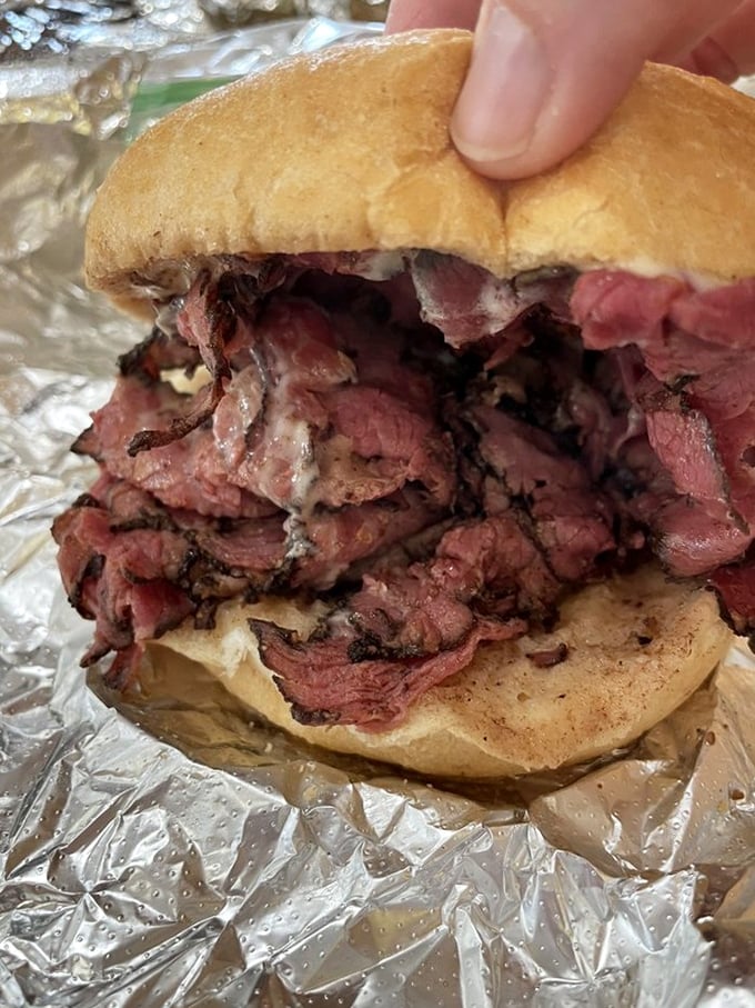 The pastrami and cheese sandwich in its natural habitat&mdash;aluminum foil, ready to be devoured by someone who knows that simplicity often trumps complexity.