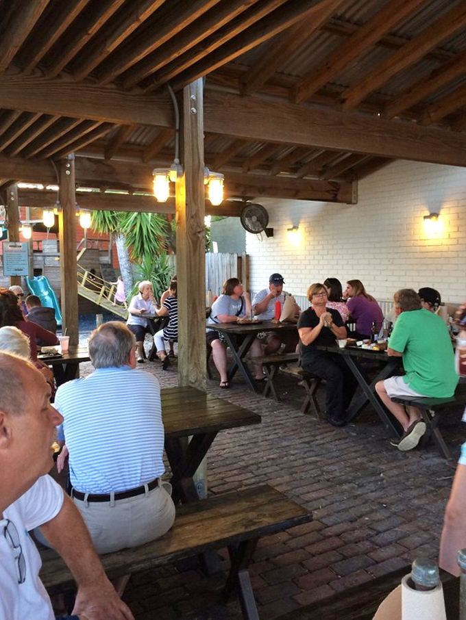 The outdoor patio offers the perfect Florida dining experience &ndash; casual wooden tables under a covered pavilion where seafood and conversation flow with equal ease.
