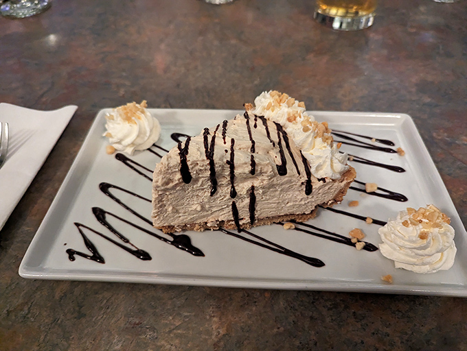 Peanut butter pie with chocolate drizzle &ndash; because after conquering the ocean's bounty, your sweet tooth deserves its own happy ending.
