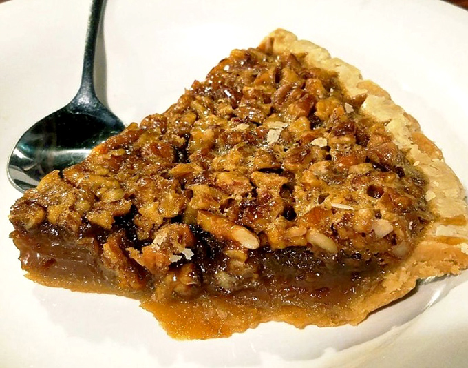 Pecan pie that makes a compelling case for skipping straight to dessert. The glistening filling and perfectly flaky crust prove Dreamland's expertise extends beyond the smoker.