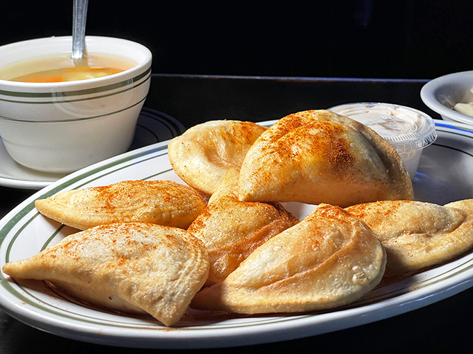 Golden-brown pierogies dusted with paprika arrive steaming hot, their pillowy exteriors hiding savory fillings that transport you straight to Eastern Europe.