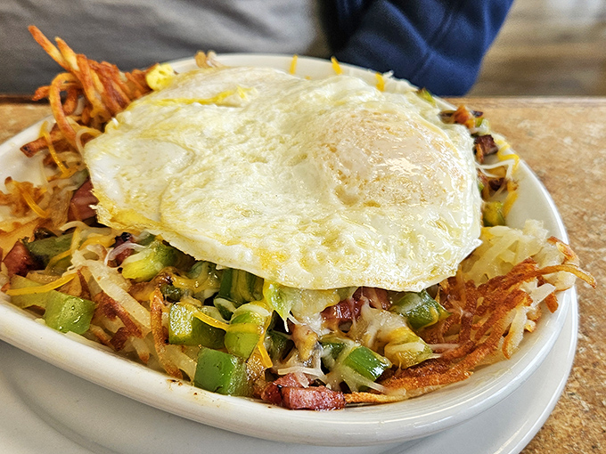 Breakfast hash topped with a perfect sunny-side-up egg&mdash;the morning masterpiece that makes hitting the snooze button worth it.