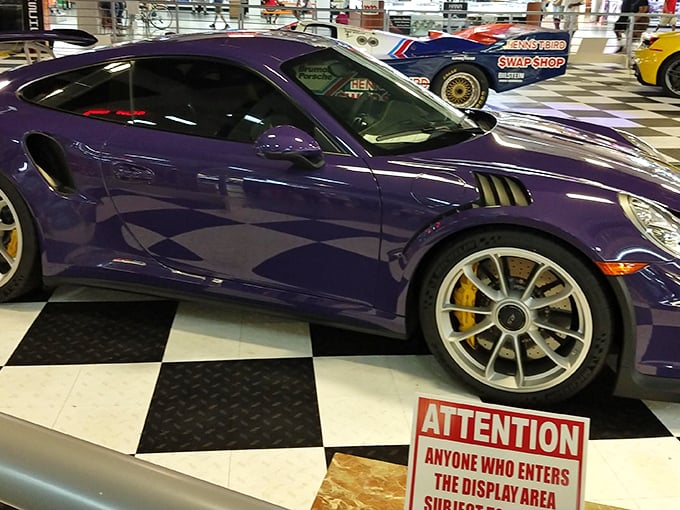 Purple Porsche gleams under museum lights, making every visitor question their current vehicle choice immediately.