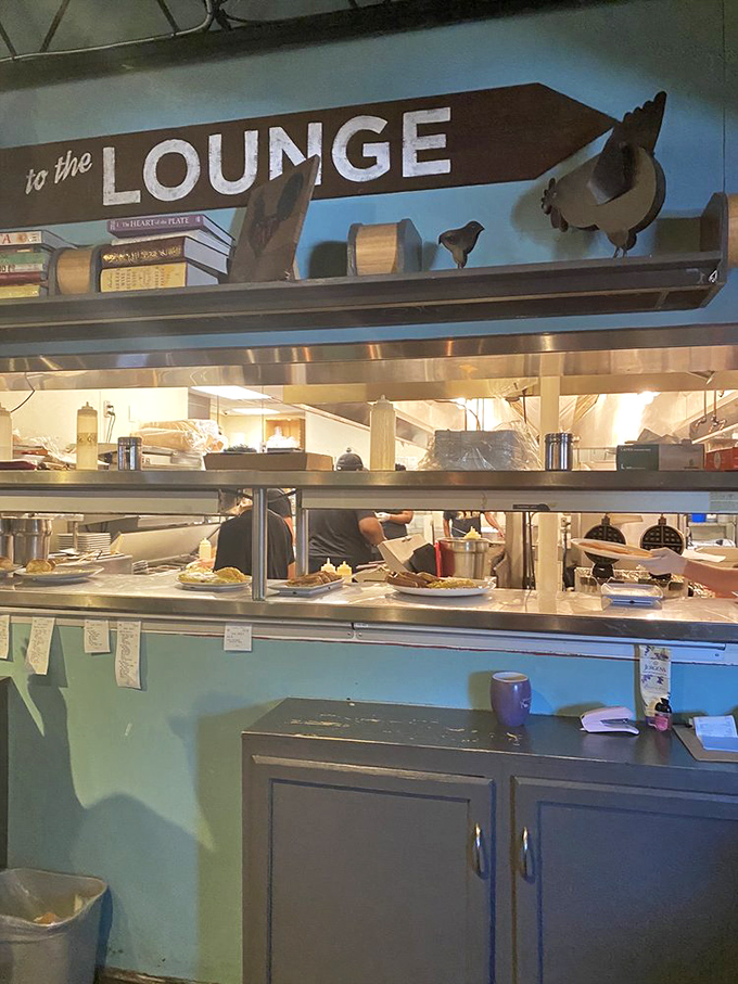 Behind every perfect breakfast is a kitchen ballet visible through the pass. Those plates lined up are about to make someone's morning significantly better.