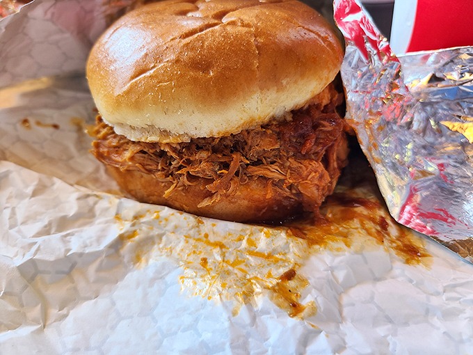 This pulled pork sandwich isn't just lunch&mdash;it's architecture. The soft bun cradles a mountain of tender, shredded pork like it was designed by Frank Lloyd Wright for hungry people.
