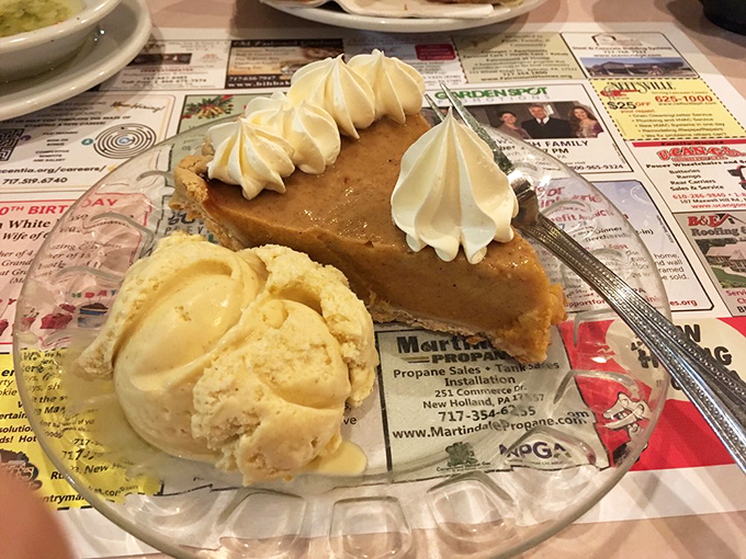 Pumpkin pie with personality—that perfect spice-to-sweet ratio crowned with whipped cream peaks. The ice cream alongside is just showing off.