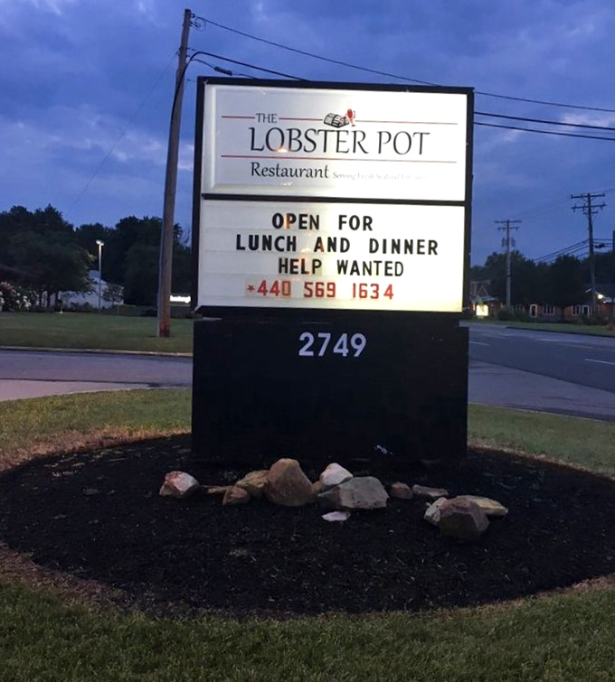 The roadside sign stands as a lighthouse for hungry travelers, guiding them to a port of culinary delights.