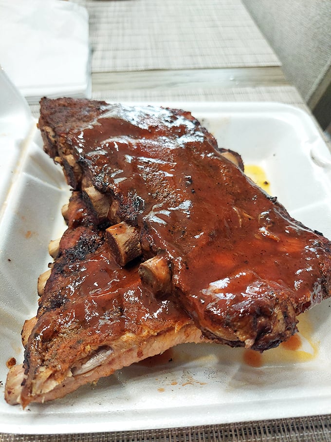 Ribs glistening with sauce like they're ready for their close-up. The bark, the pull, the shine—it's barbecue poetry.