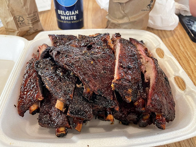 Behold, meat candy! These ribs sport the kind of smoke ring and bark that would make pitmasters weep and vegetarians reconsider their life choices.