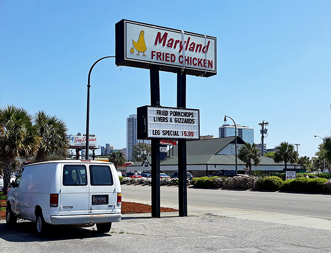 The roadside sign stands like a beacon of hope for hungry travelers&mdash;follow it to fried chicken salvation.
