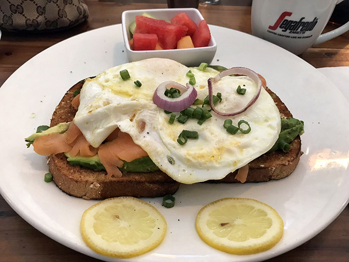 Salmon avocado toast that bridges the gap between "health food" and "food you actually want to eat," topped with an egg that's perfectly sunny.