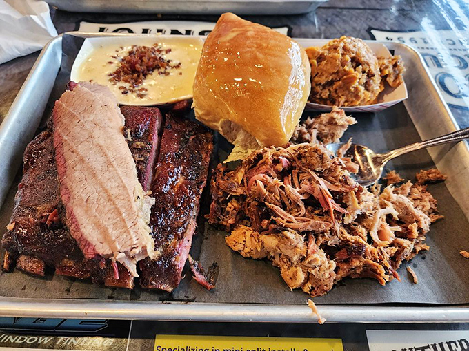 The BBQ sampler platter&mdash;nature's way of saying "you don't have to choose." Brisket, pulled pork, and a roll that's ready to soak up every last drop of sauce.