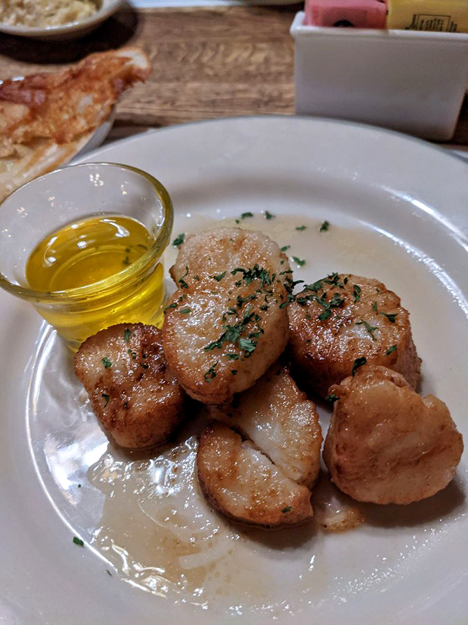 Scallops seared to golden perfection, glistening with butter and herbs—little ocean treasures that somehow found their way to Canton.