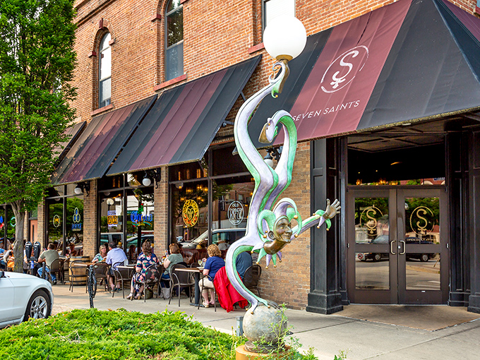 Seven Saints' whimsical sculpture guards the entrance like a tipsy mythological creature who's found its perfect perch.