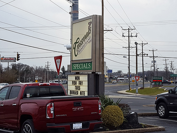 The roadside sign announces daily specials like a town crier, beckoning hungry travelers with promises of Fish Fry Mondays and Burger Nites.