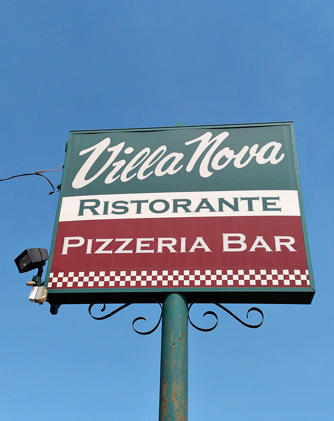 The iconic Villa Nova sign stands proud against blue Ohio skies. Those Italian flag colors aren't just decoration&mdash;they're a promise of the authentic experience waiting inside. 