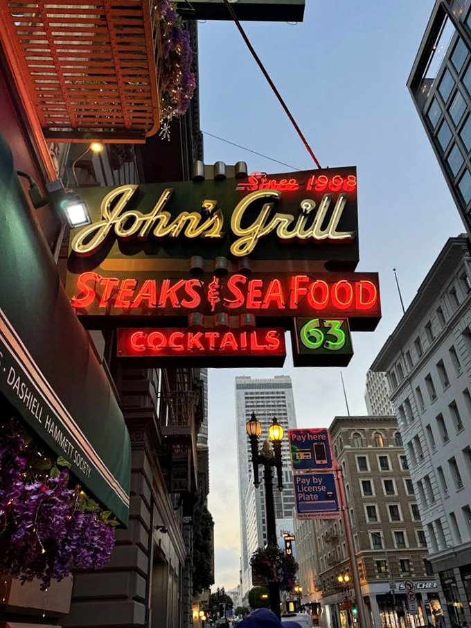 As dusk falls, the neon sign glows like a lighthouse for hungry souls navigating the urban sea of downtown San Francisco.