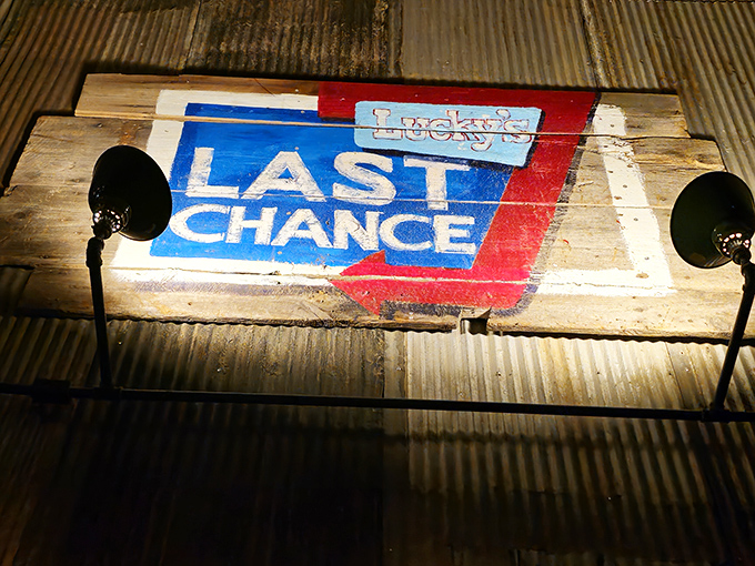The Lucky's Last Chance logo painted on reclaimed wood &ndash; rustic charm that perfectly captures the vibe.
